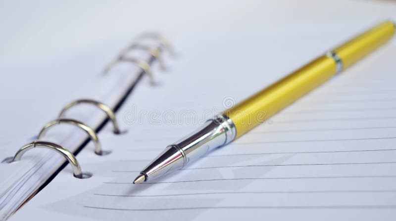 Golden Pen on note pad stock photo. Image of future, arrange - 93844192