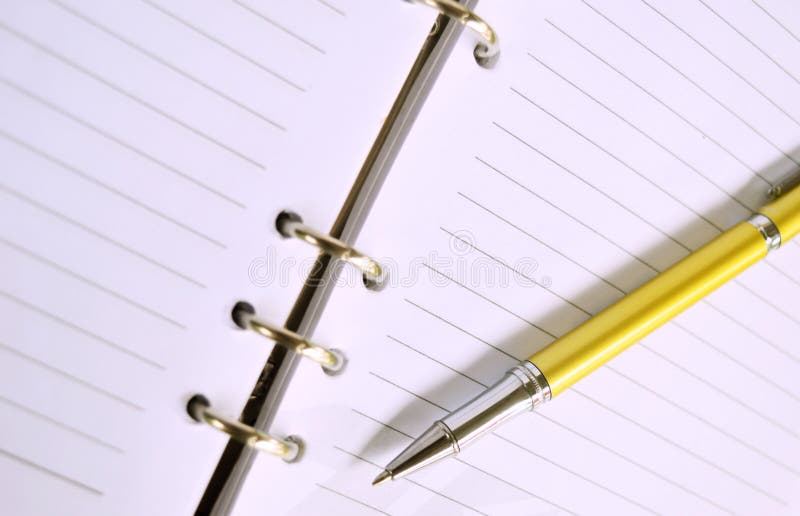 Golden Pen on note pad stock image. Image of business - 93844195