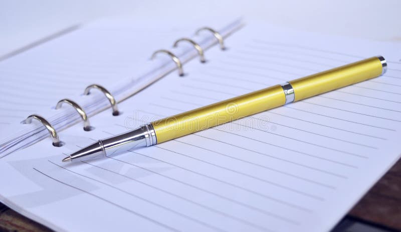 Golden Pen on note pad stock photo. Image of blank, note - 93844220