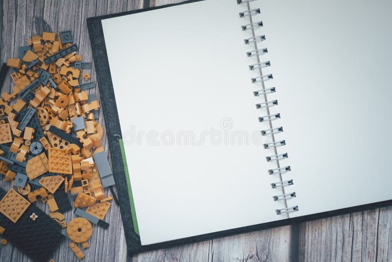 Golden Plastic Blocks with Empty Paper Notebook Stock Image - Image of ...