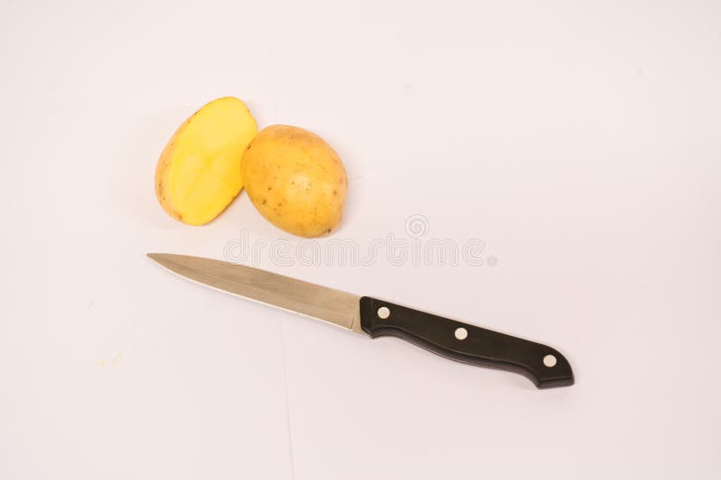 Golden Potato Split with Precision Knife Stock Photo - Image of cooking ...