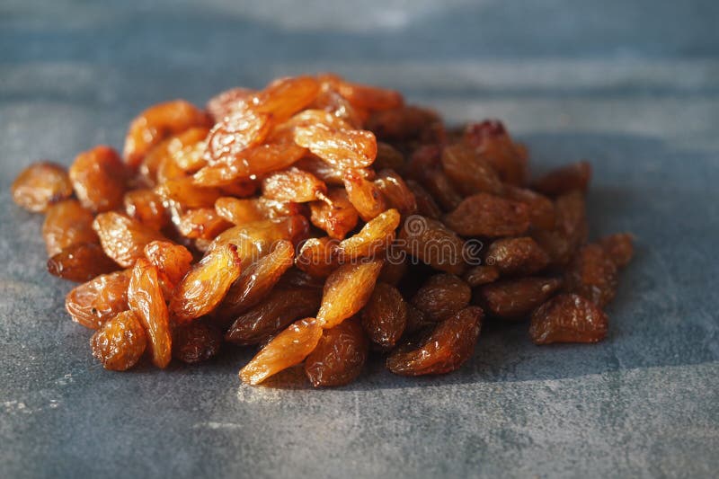 Golden Raisins Piled on a Textured Surface in Natural Light Stock Image ...