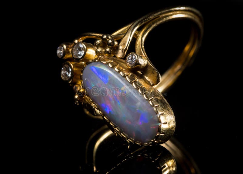 A Golden Ring with a Colorful Opal Gemstone Stock Photo - Image of ...