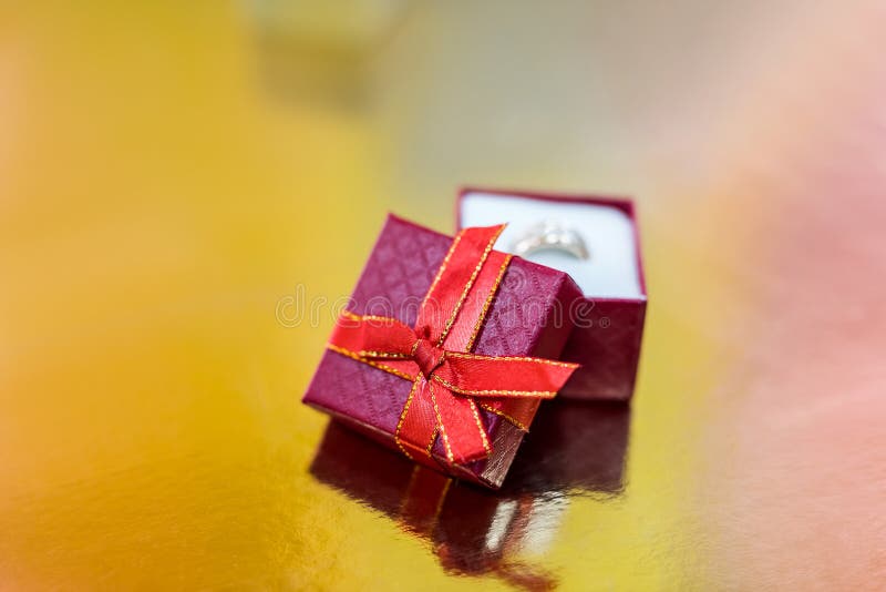 Golden Ring in Red Present Box on Golden Background Stock Photo - Image ...