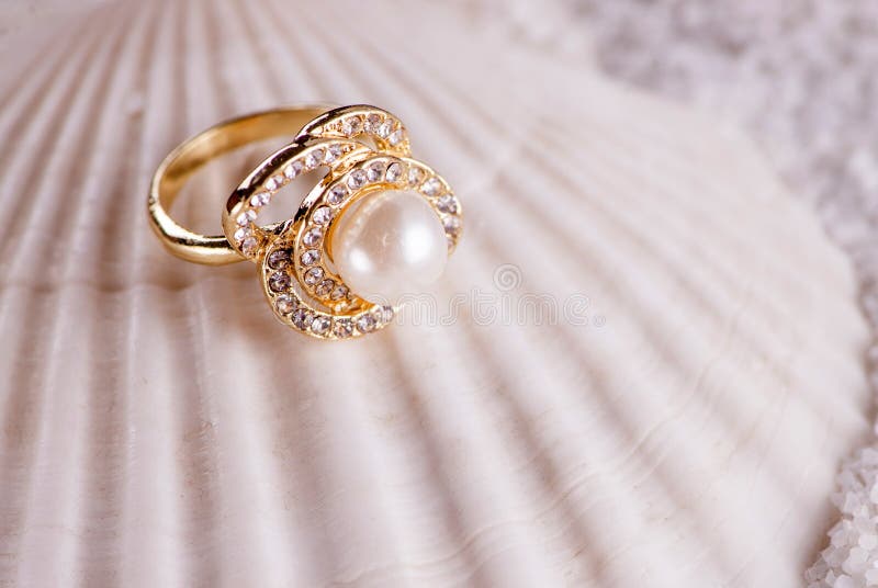 Golden ring and sea shell stock image. Image of diamond - 232527139