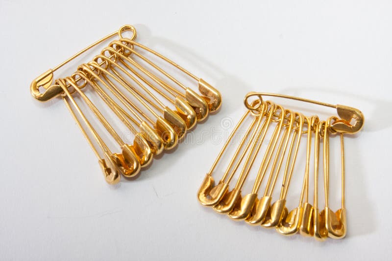 Golden Safety Pin on a White Background Stock Photo - Image of gold ...