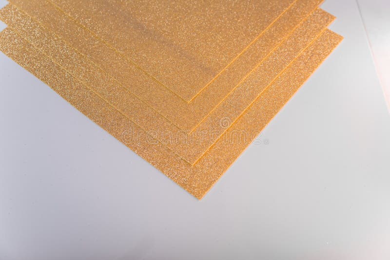 Golden Sheets of Cardboard with Sparkles on a White Background Stock ...