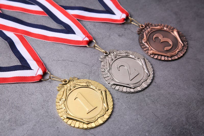 Golden, Silver and Bronze Medals on Grey Background, Closeup Stock ...