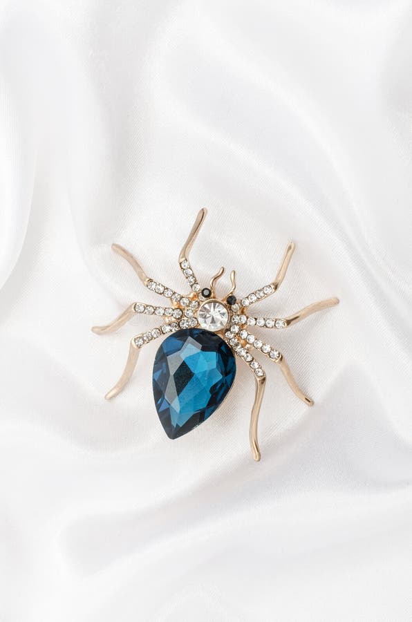 Golden Spider with a Big Blue Stone on Silk Fabric Stock Image - Image ...