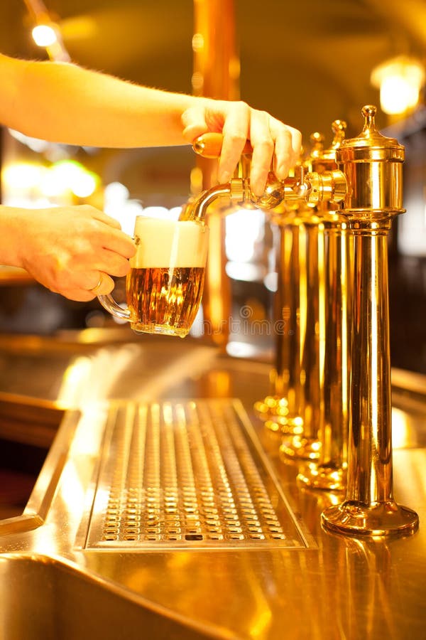 Golden spigot with beer stock image. Image of malt, refreshing - 23468393