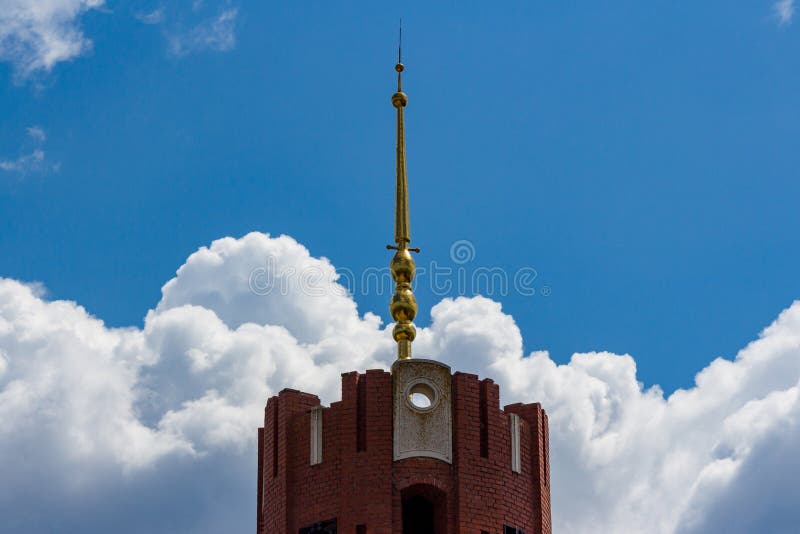 A Golden Spire Over a Building Against a Blue Sky Stock Image - Image ...