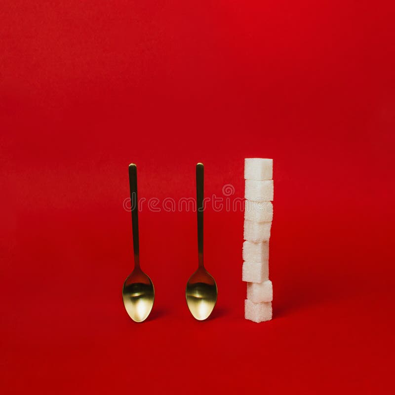 Golden Spoons and Stack of Sugar Cubes on Red Stock Image - Image of ...
