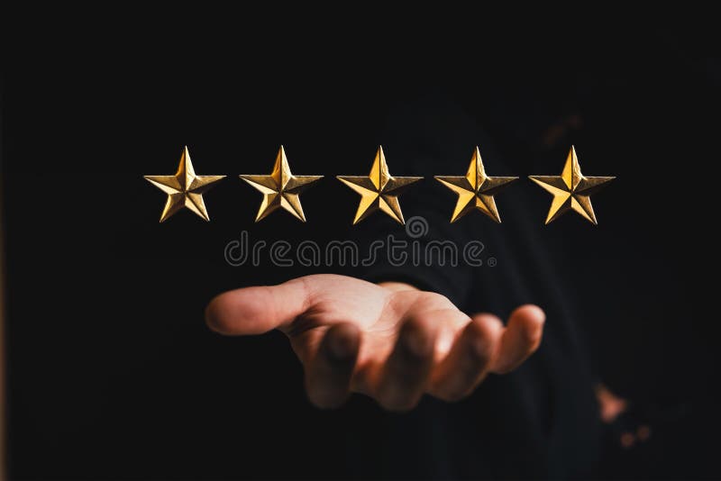 Golden Star Rating on Hand in Dark Background Stock Image - Image of ...
