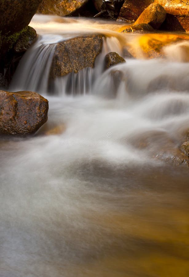 Golden Stream Cascade stock image. Image of boulders - 21781427