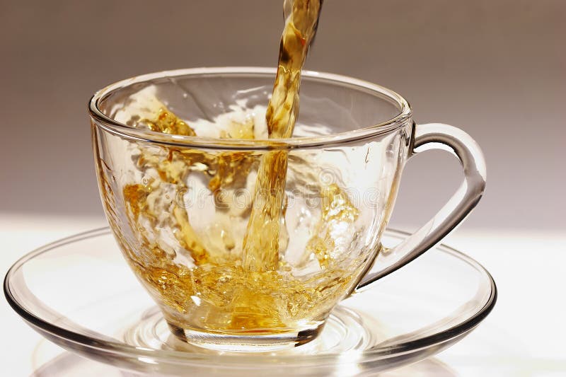 Golden stream of tea 3 stock photo. Image of pouring, serenity - 1132058