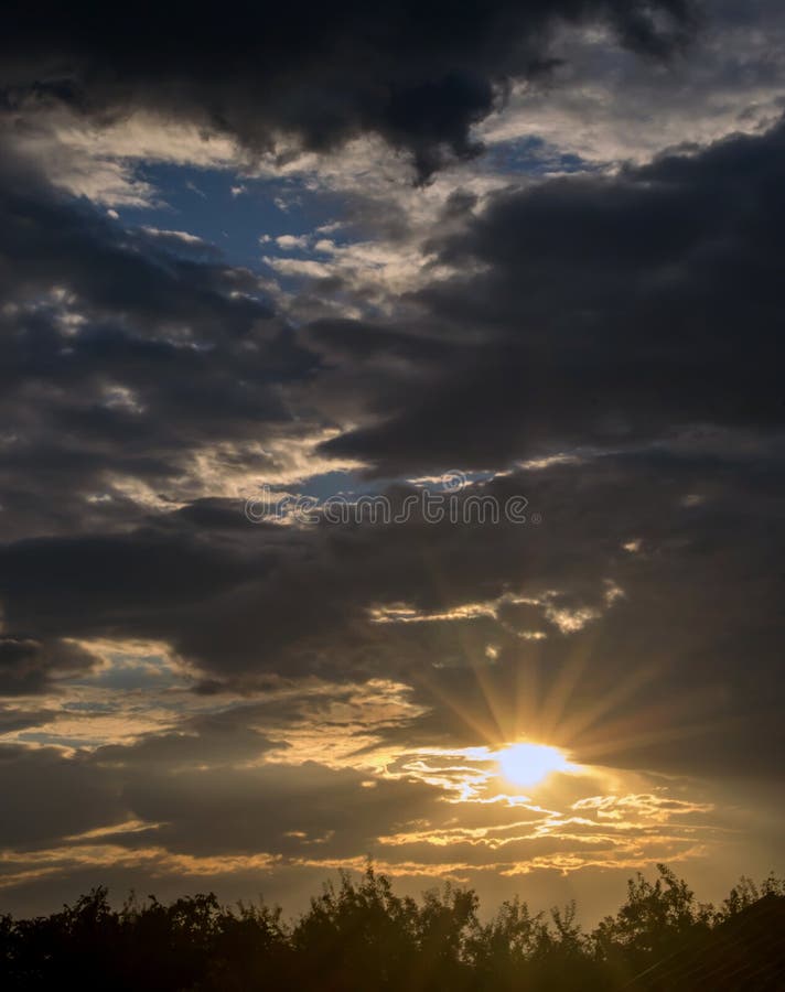 Golden Sun Rays through the Clouds Stock Image - Image of rays, sunset ...
