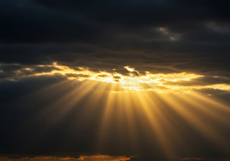 Golden Sun Rays Streaming through Dramatic Dark Clouds: a Stunning ...