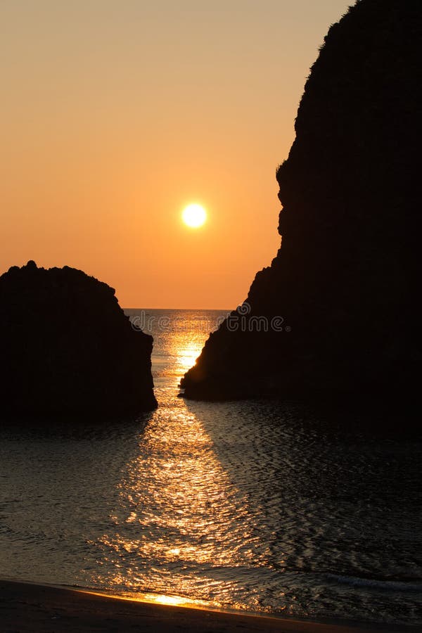 Sun Sets between Two Large Rocks Stock Photo - Image of sets, rocks ...
