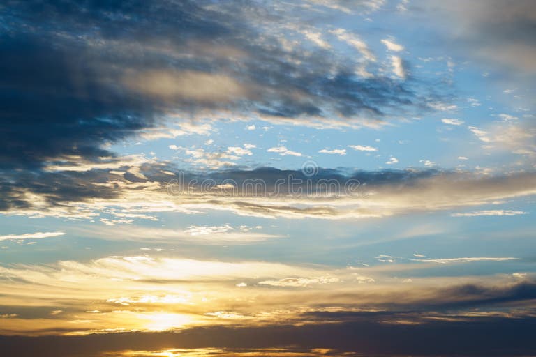 Golden Sunlight Breaks through Layers of Dark and Light Clouds in a ...