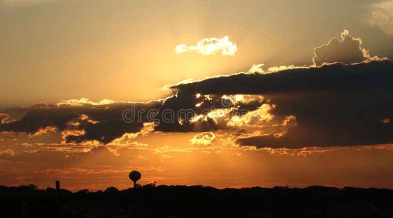 Golden Sunset with Clouds Over Land Stock Photo - Image of clouds, calm ...