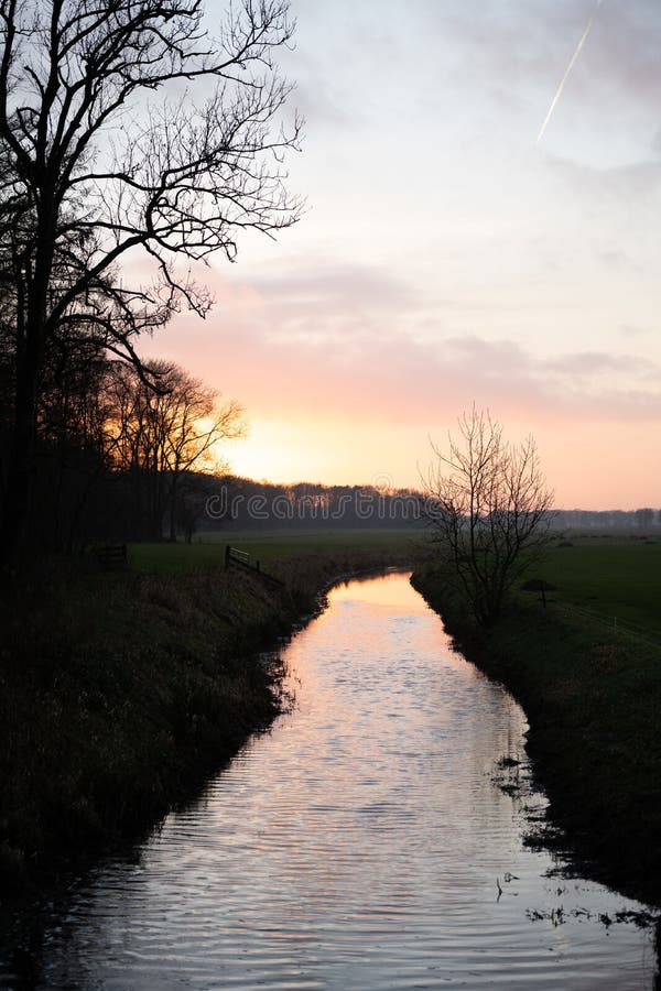 Golden Sunset with a River Running through a Field in the Netherlands ...