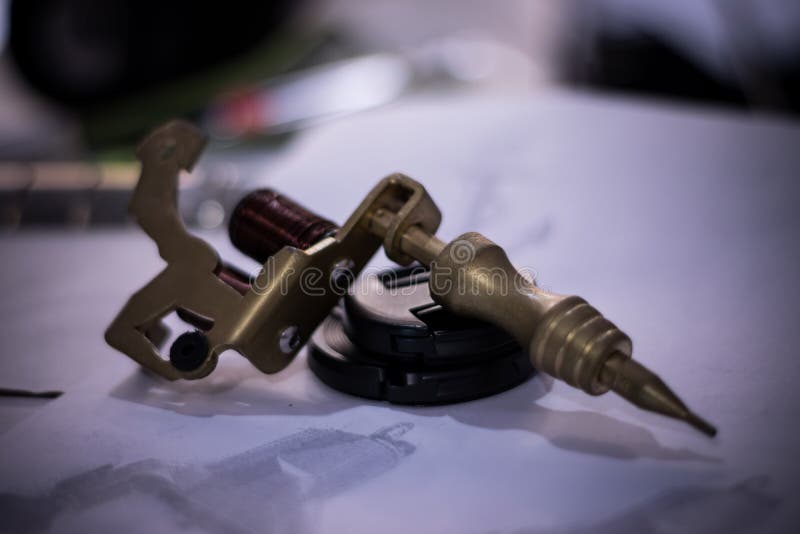 Golden tattoo machine stock image. Image of studio, tattoos - 177774019