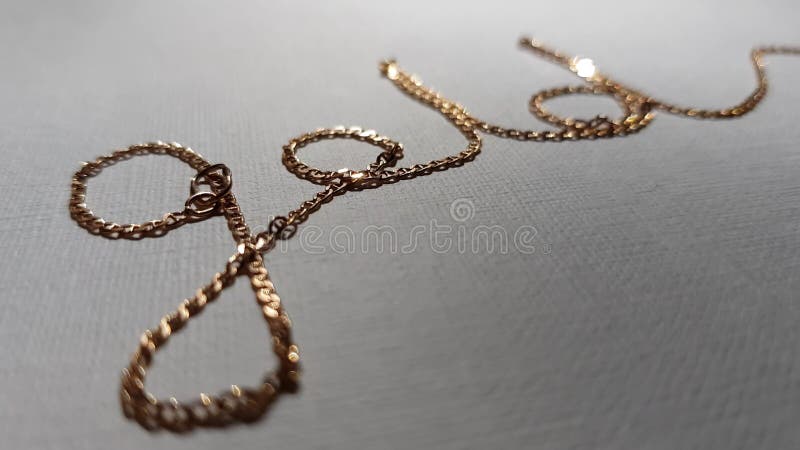 Golden Text from a Gold Chain on a White Table Stock Footage - Video of ...