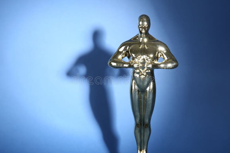 Golden Trophy in Shape of Human Figure on Blue Background, Space for ...