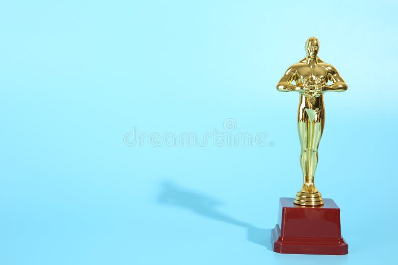 Golden Trophy in Shape of Human Figure on Light Blue Background, Space ...