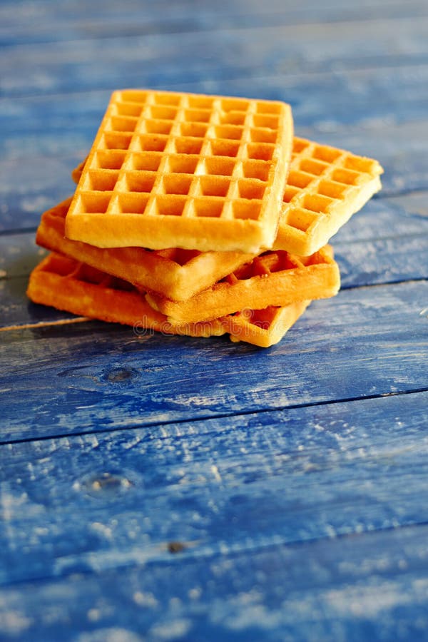 Golden Waffles on Blue Wooden Table Stock Photo - Image of wooden ...