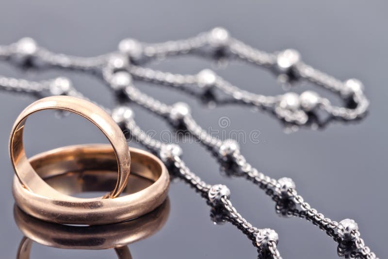 Golden Wedding Rings and Elegant Silver Chain Stock Photo - Image of ...