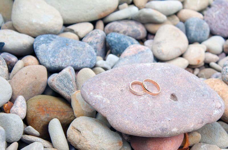 Golden Wedding Rings on a Stones. Rustic Wedding Concept. Stock Photo ...