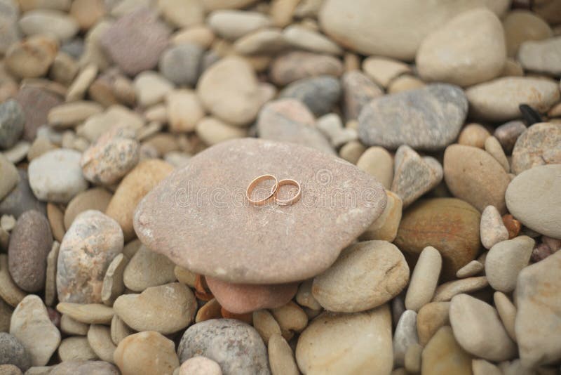 Golden Wedding Rings on a Stones. Rustic Wedding Concept. Stock Image ...