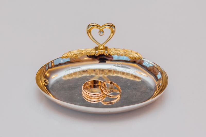 Golden Wedding Rings on a Plate Stock Image - Image of gold, ribbon ...
