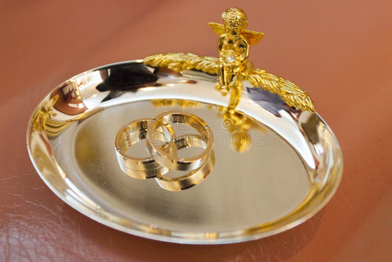 Golden Wedding Rings on Silver Plate with Figure of Angel Stock Image ...