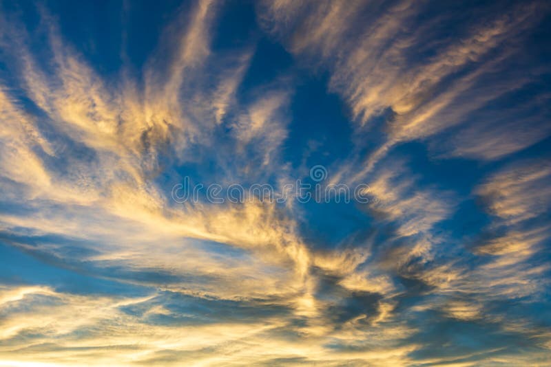Golden Wispy Clouds, Blue Sky in Background. Stock Photo - Image of ...
