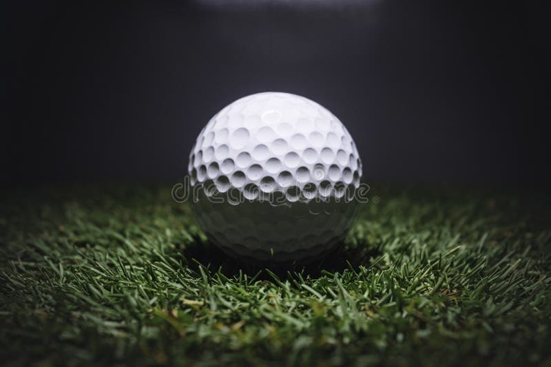 Golf Ball Against Dark Backdrop, Illuminated To Showcase Its Dimpled ...