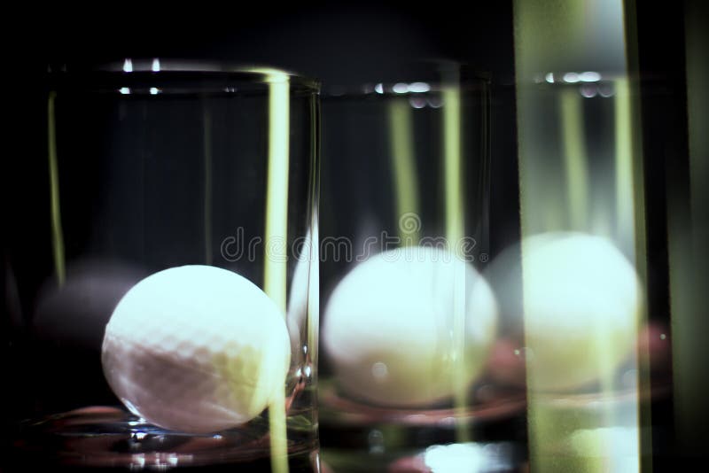 Golf Ball Inside a Clear Glass Cup Stock Photo - Image of splash ...