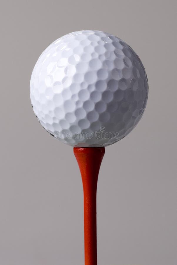 White Golf Ball on Red Tee stock photo. Image of isolated - 12514126