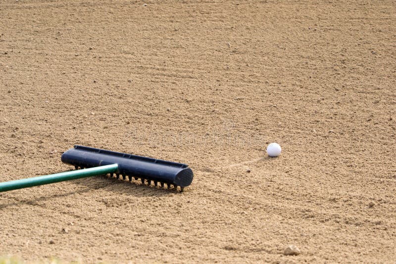Golf Ball in a Sand Trap with a Rake Stock Photo - Image of sports ...