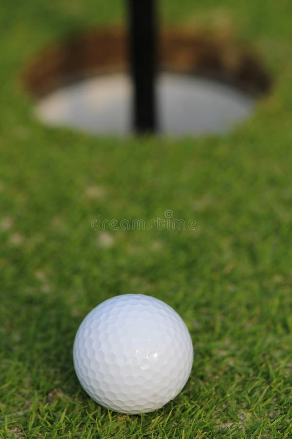 Golf Ball about To Fall into the Cup, on Green Grass Stock Image ...