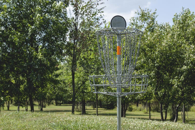 Golf Basket on a Course in Front of Trees Stock Image - Image of golf ...