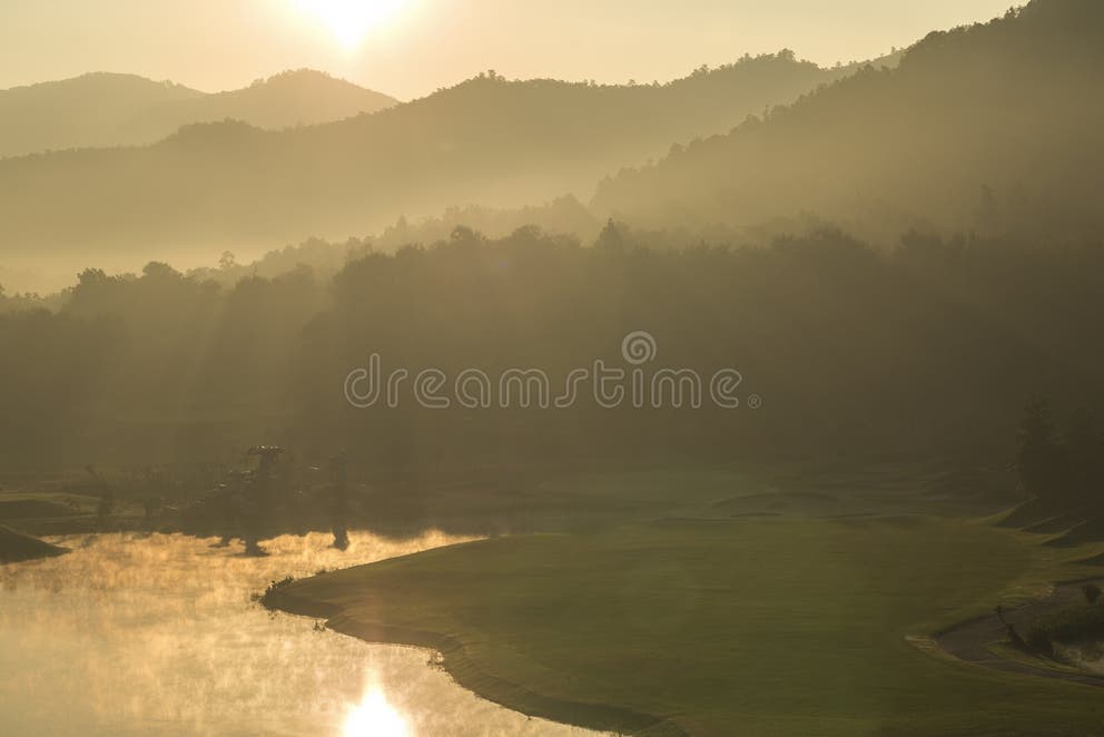 Golf Course at Dawn Backlit by Rising Sun Stock Photo - Image of life ...