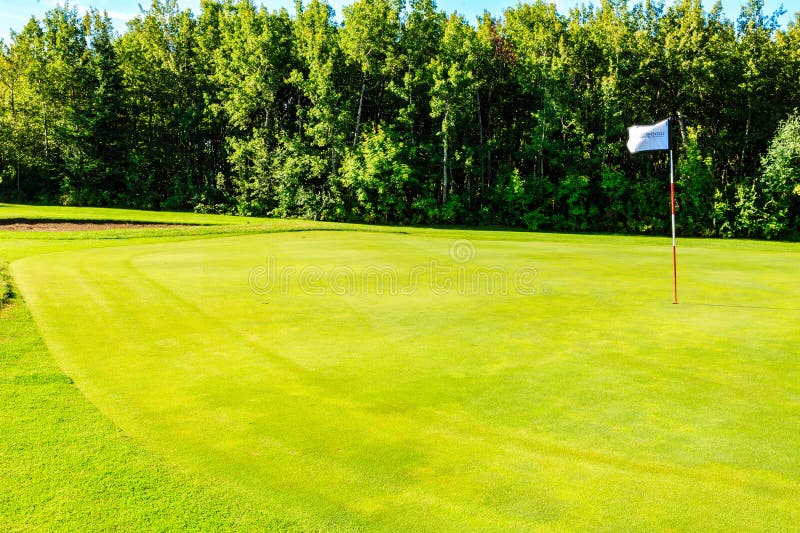 A Golf Course with a Green Grass Field and a Flagpole Stock Image ...