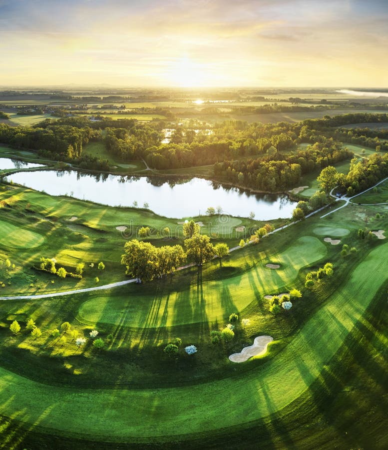 Golf Course Panorama at Dramatic Sunrise with Green Fairways and Forest ...