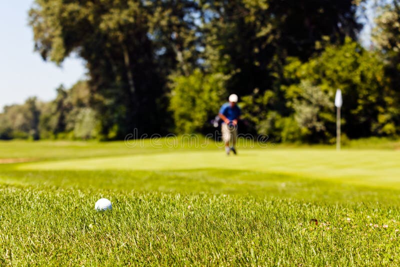 Golf course with players stock image. Image of ball, blue - 73787511