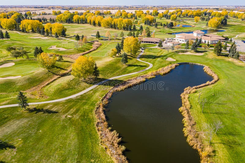 Golf Course with a Pond and Trees in the Background Stock Photo - Image ...