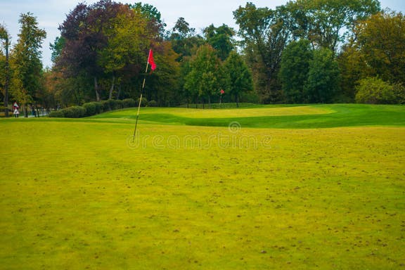 Golf Course with Red Flag stock photo. Image of hole - 171871924