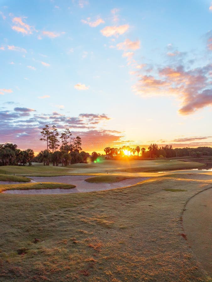 Golf Course Sunset with Sprinklers in the Sunset Stock Photo - Image of ...