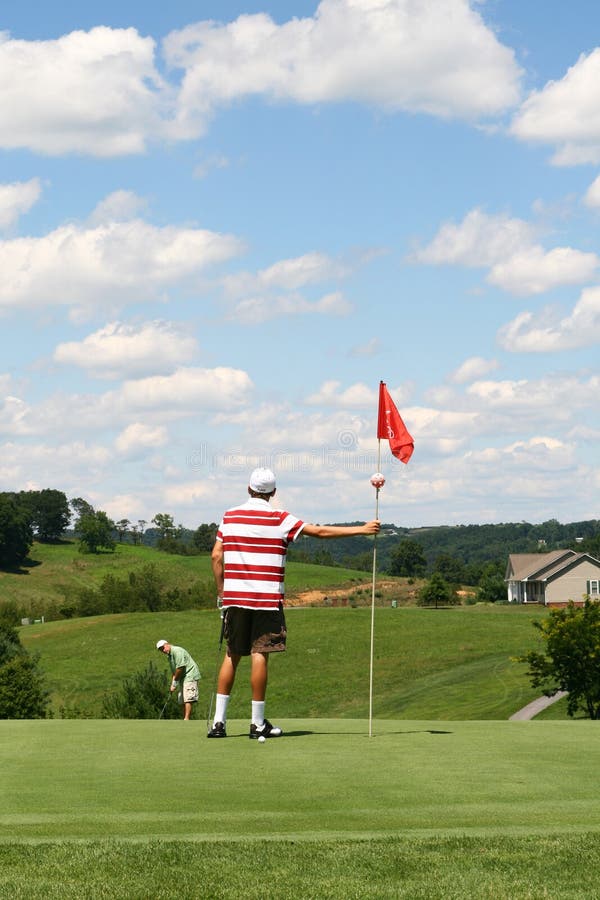 Golf - Father Putting Ball at Son Tending Flag Stock Photo - Image of ...
